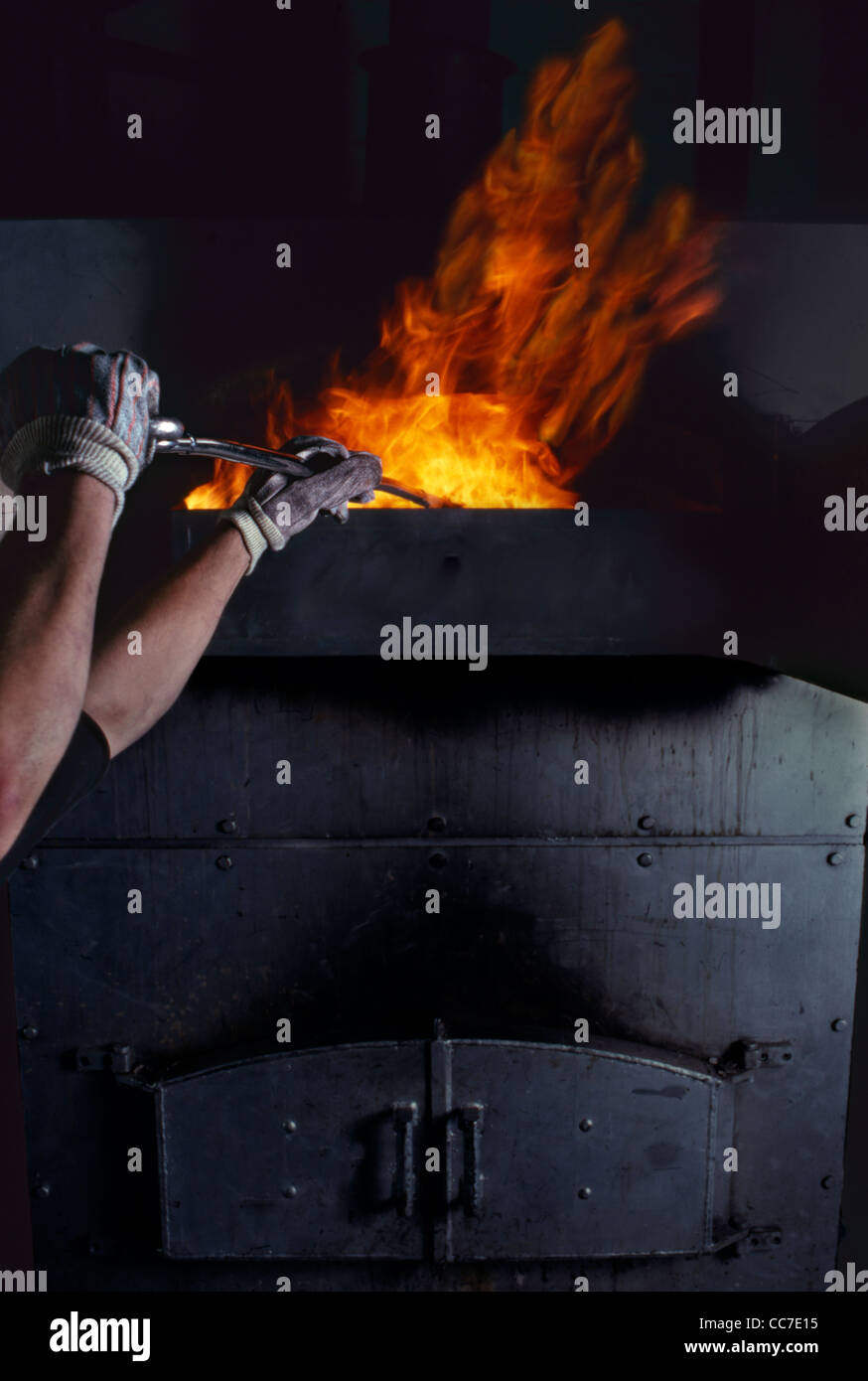 Workman Maintaining Furnace Stock Photo - Alamy