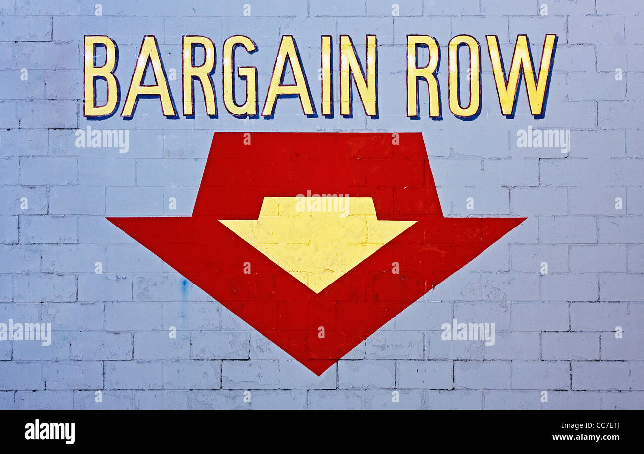 humorous store sign painted on outside wall Stock Photo - Alamy