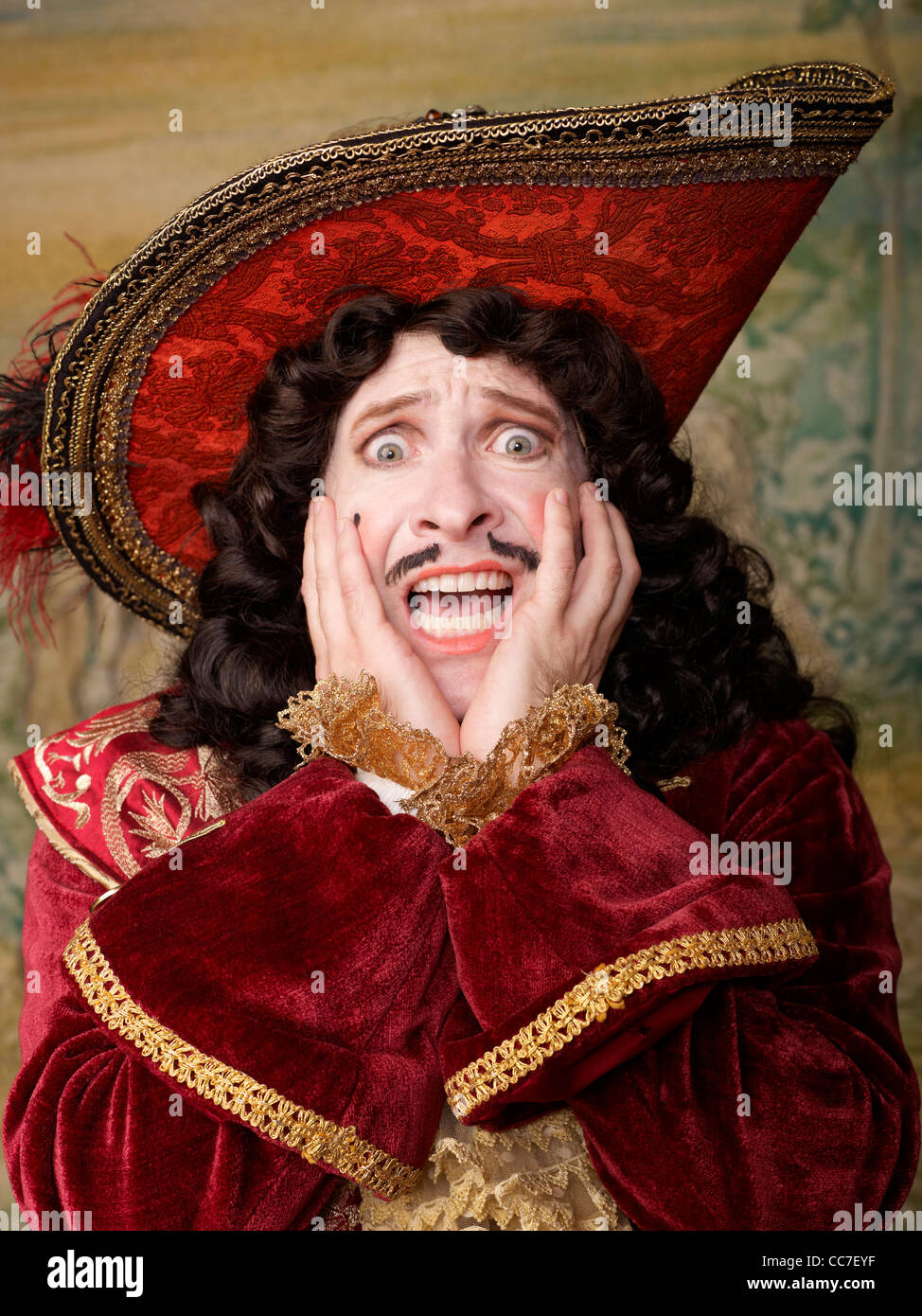 Shocked actor dressed in old-fashioned costume on stage Stock Photo - Alamy