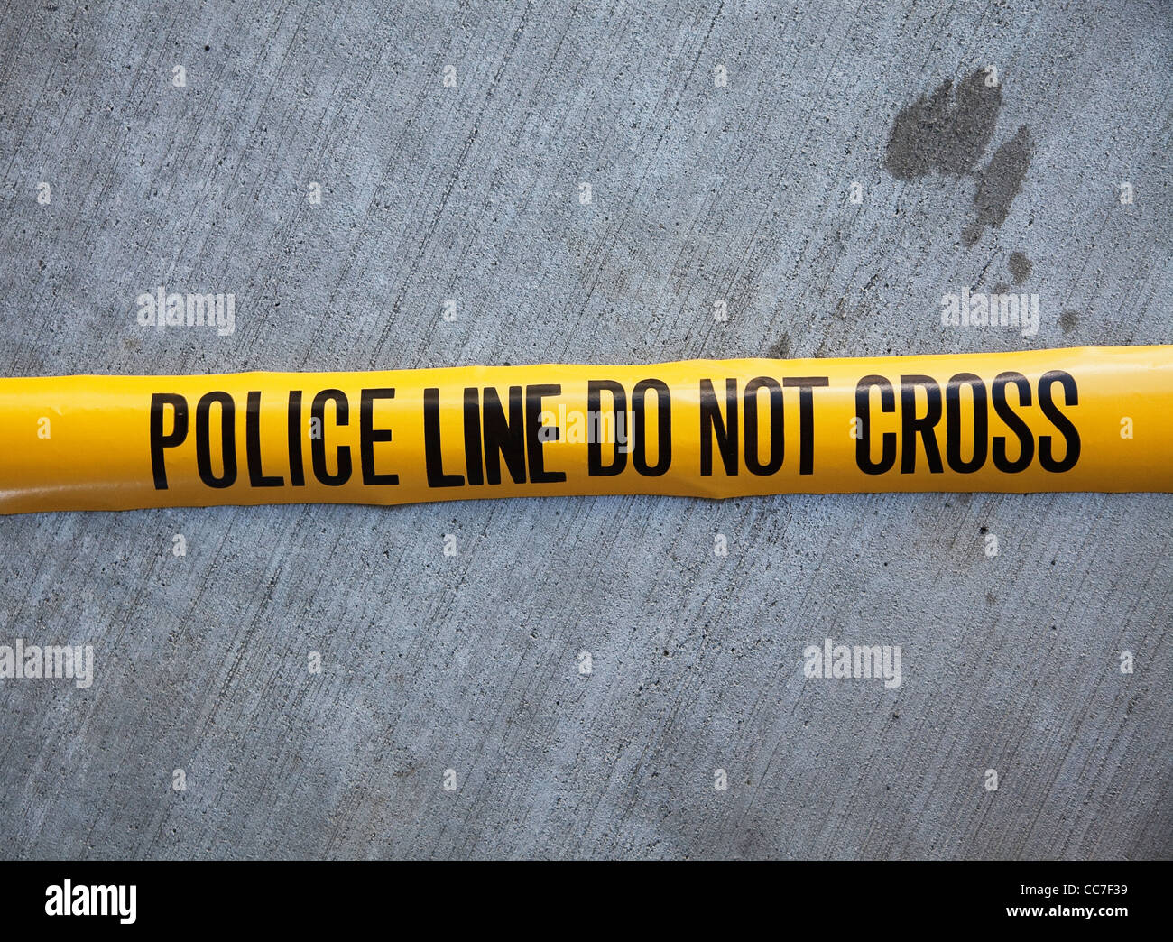 police line do not cross tape set against concrete sidewalk Stock Photo ...