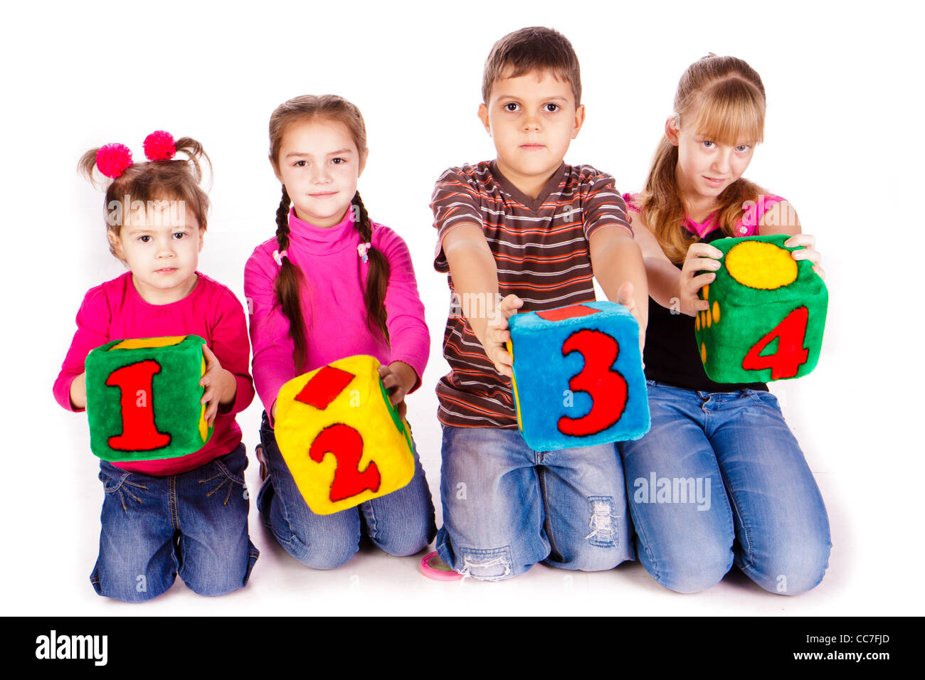 Happy kids holding blocks with numbers over white background Stock ...