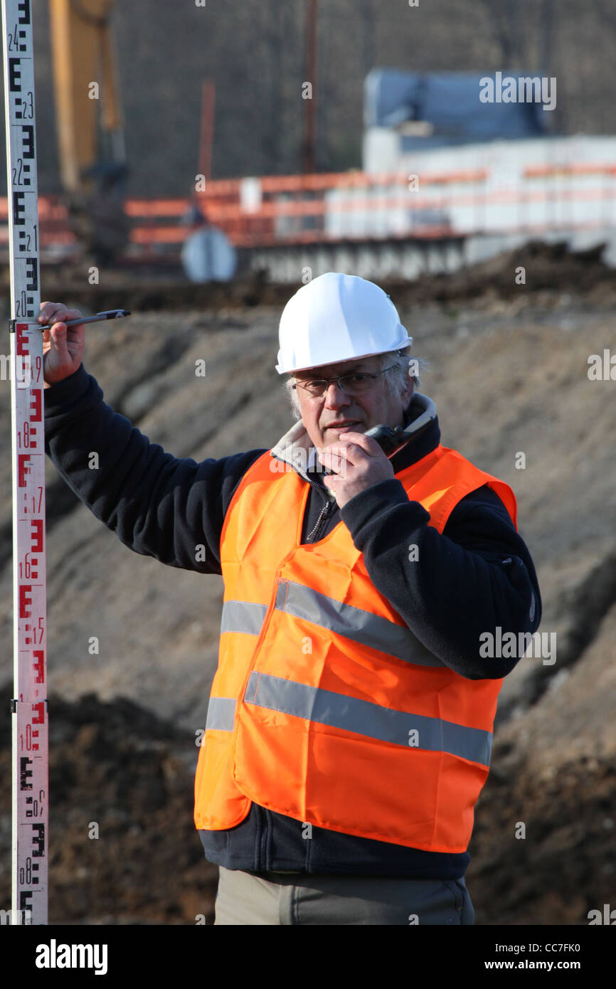 Civil engineer with an elevation reader Stock Photo - Alamy