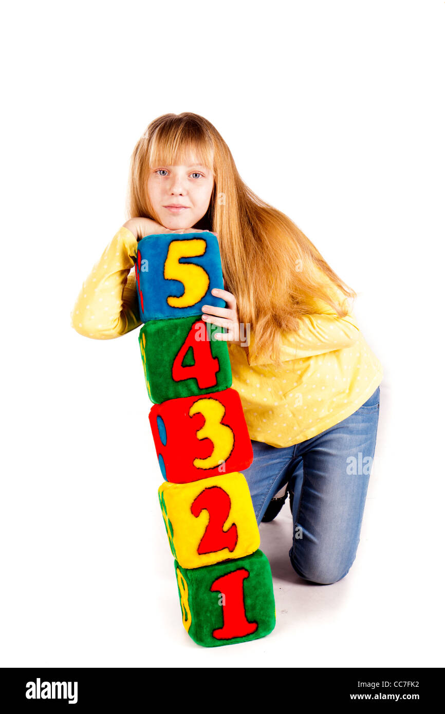 Happy girl holding blocks with numbers over white background Stock ...