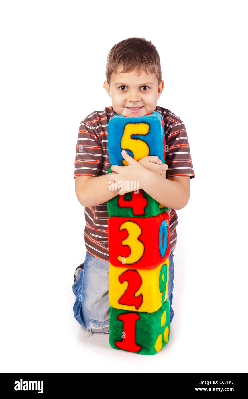 Happy boy holding blocks with numbers over white background Stock Photo ...