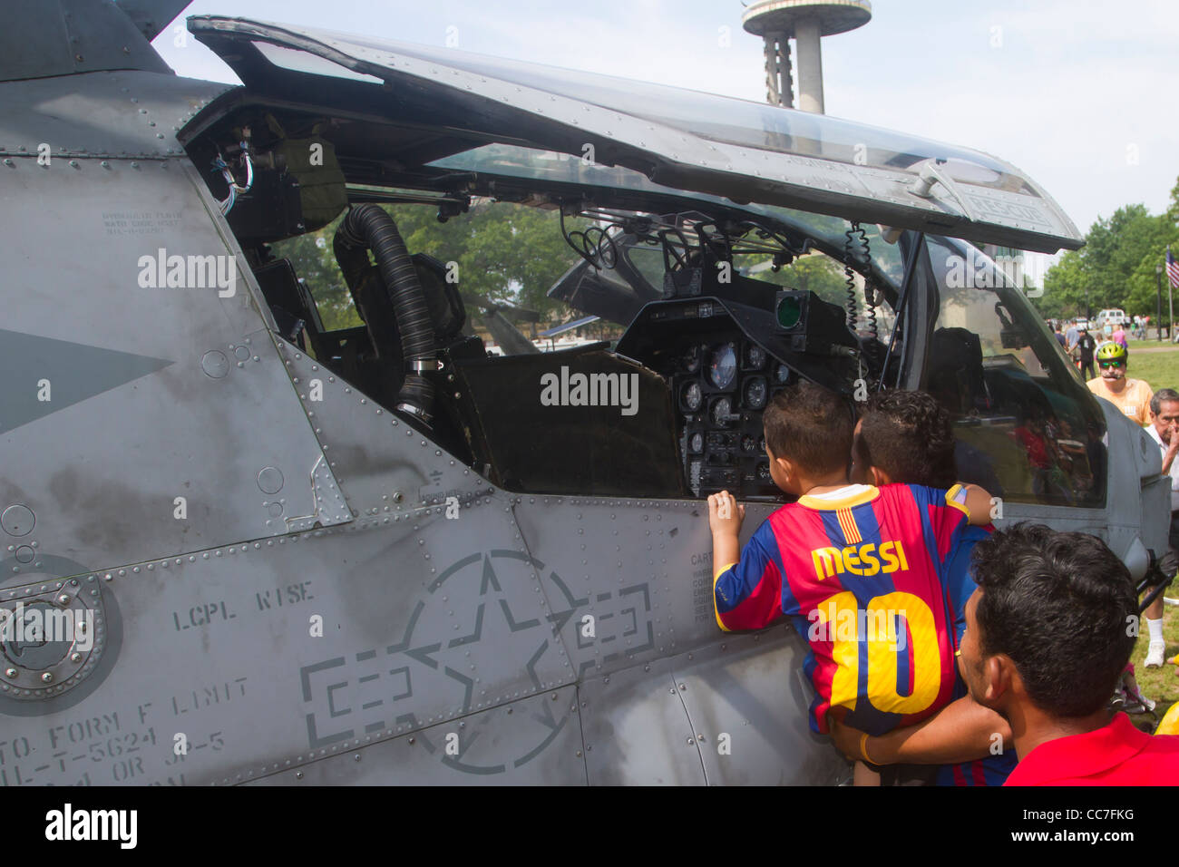 A young boy peers into the cockpit of a Marine Corps AH-1 Super Cobra ...