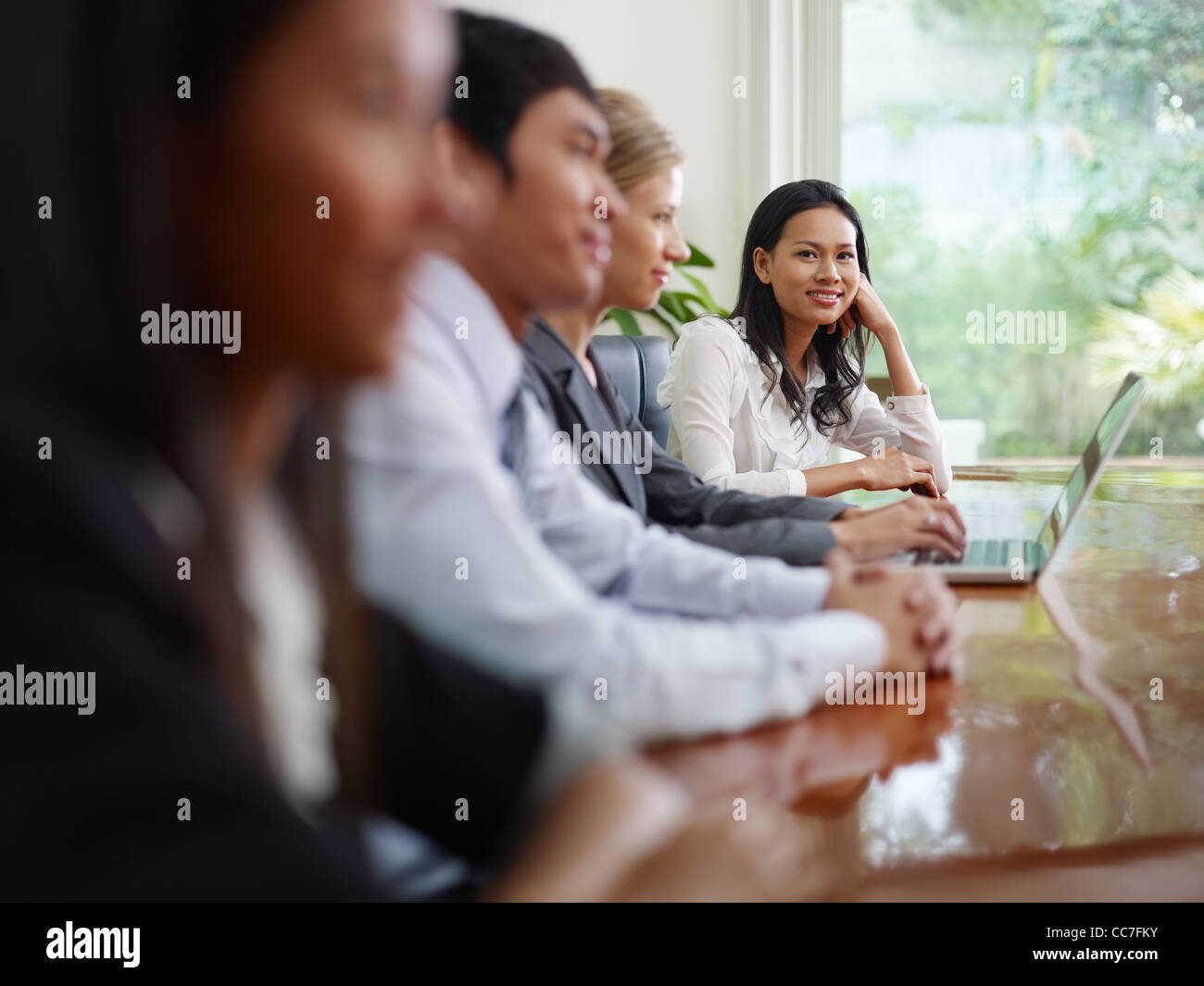 Beautiful young asian woman working and smiling at camera during ...