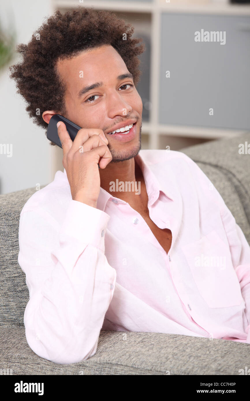 Young man making a call at home Stock Photo - Alamy