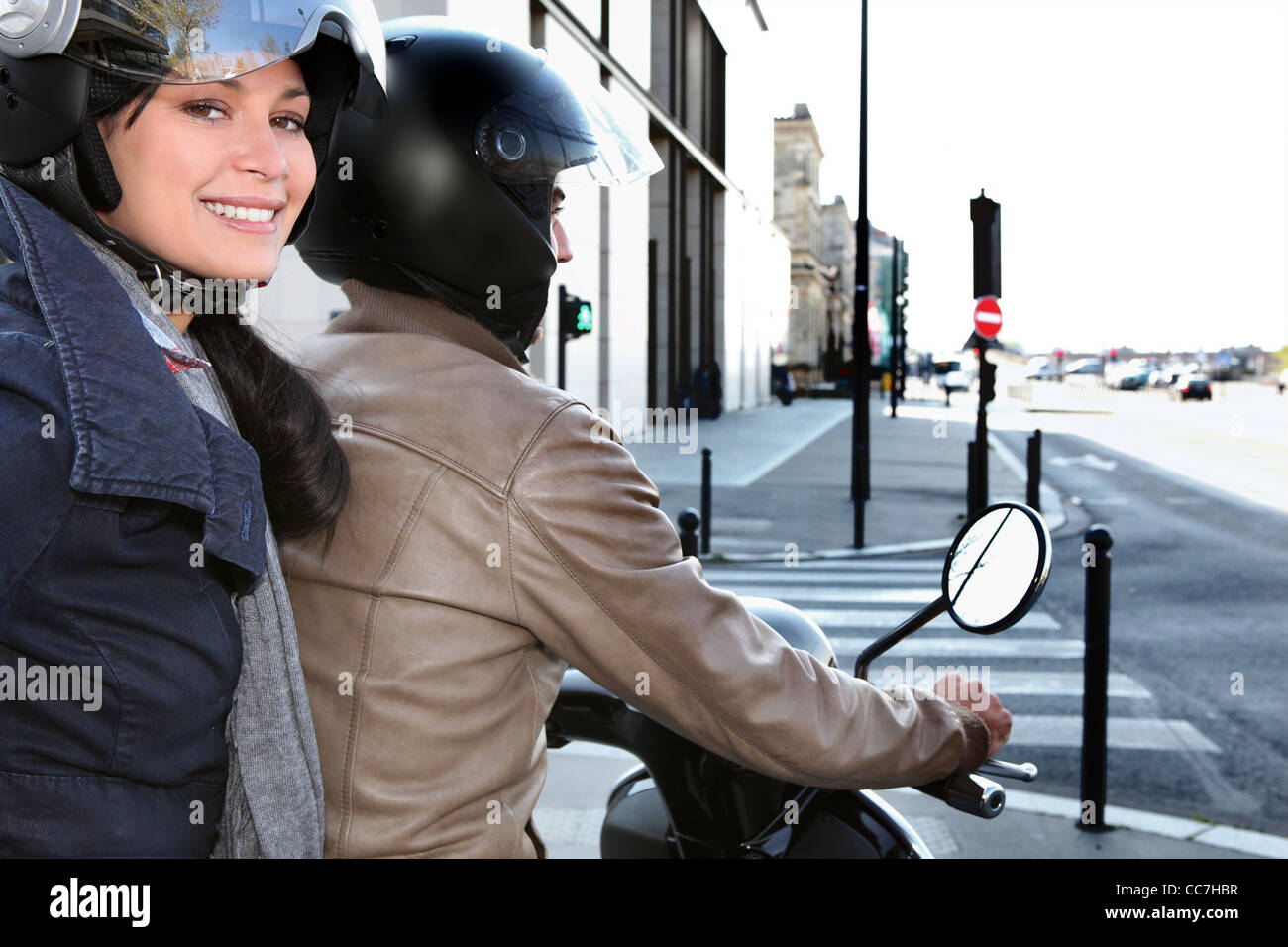 Trendy couple on a moped Stock Photo - Alamy