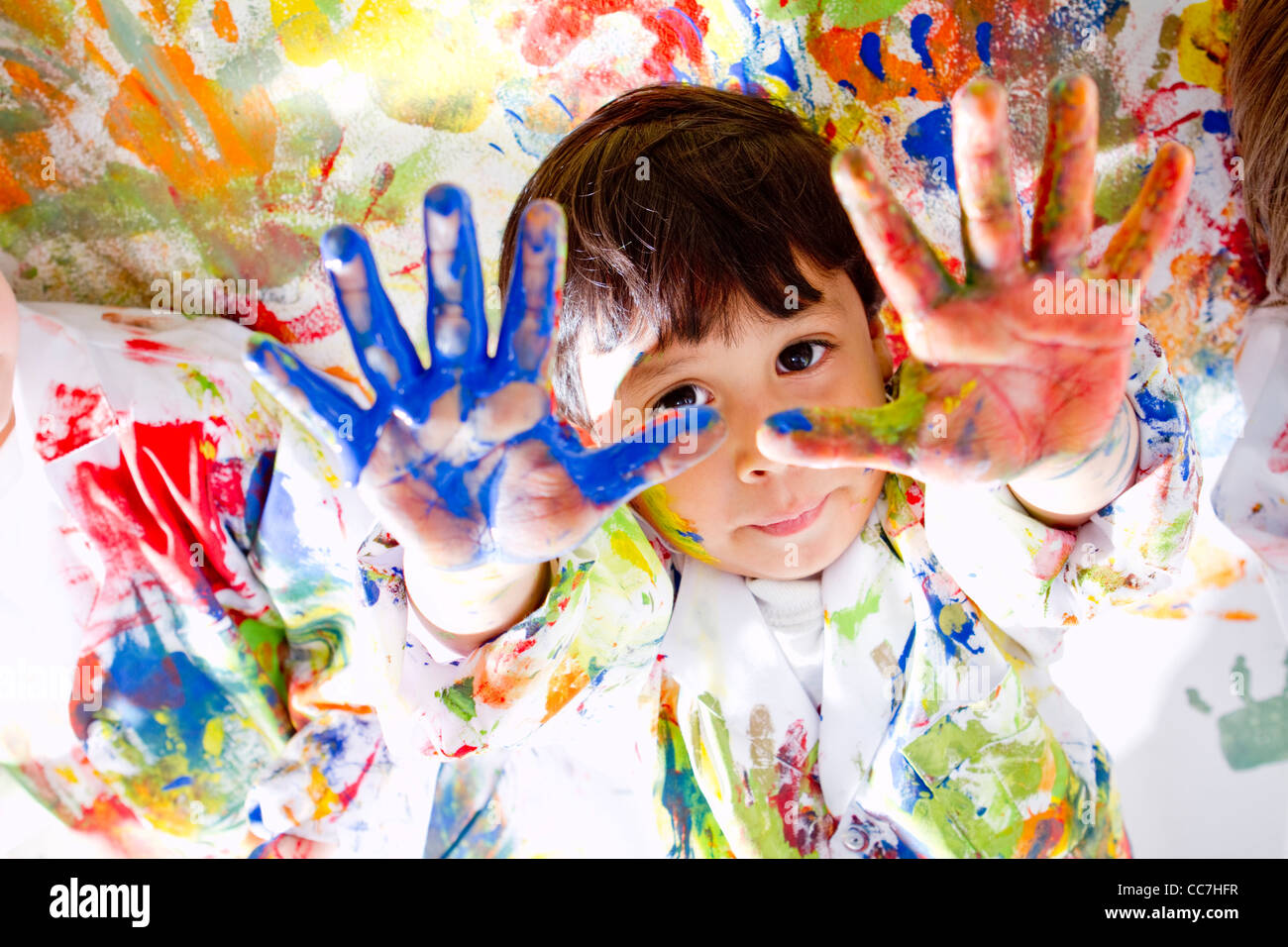 Messy Hispanic boy finger painting Stock Photo - Alamy