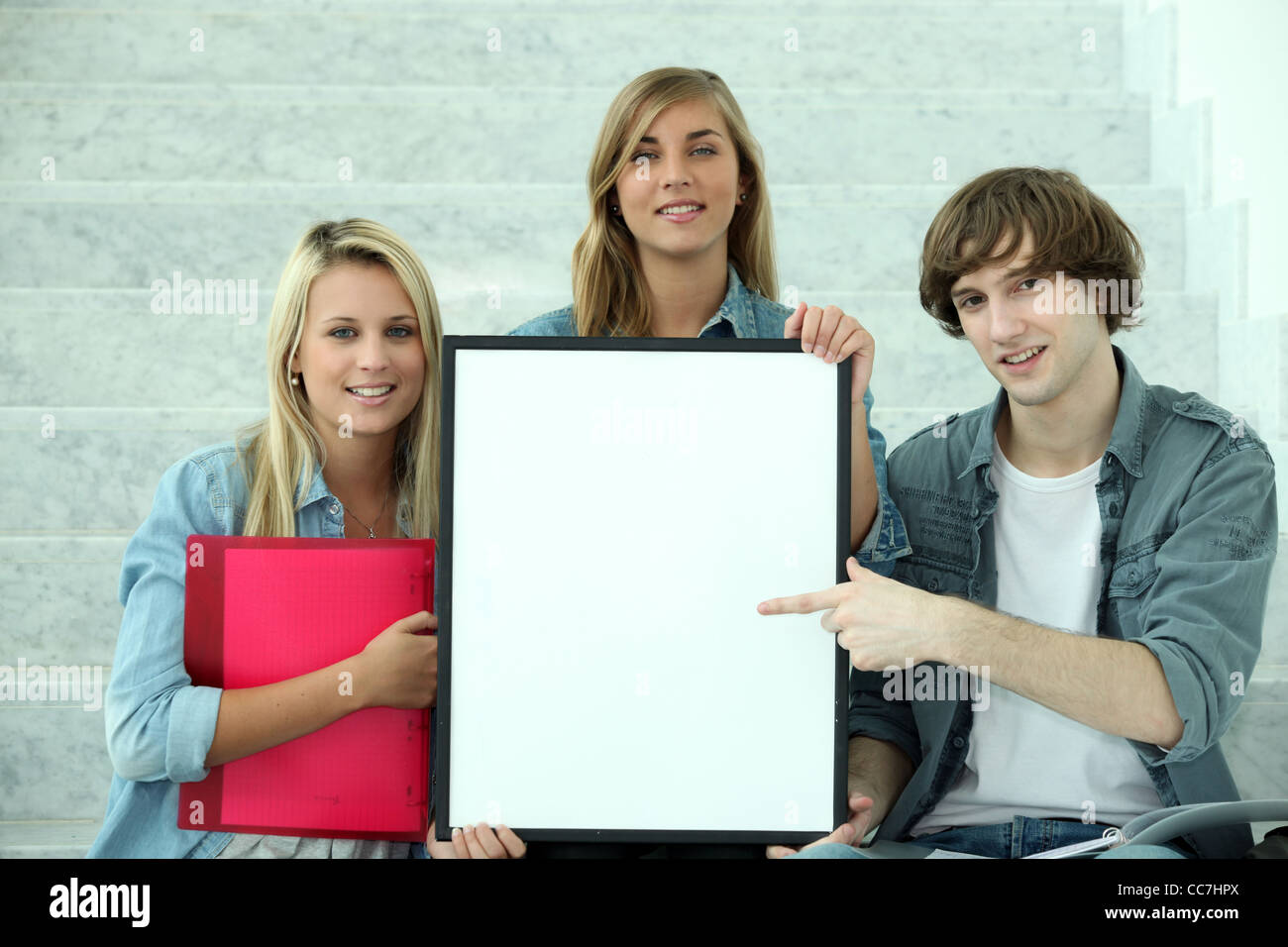Students pointing at white board Stock Photo - Alamy