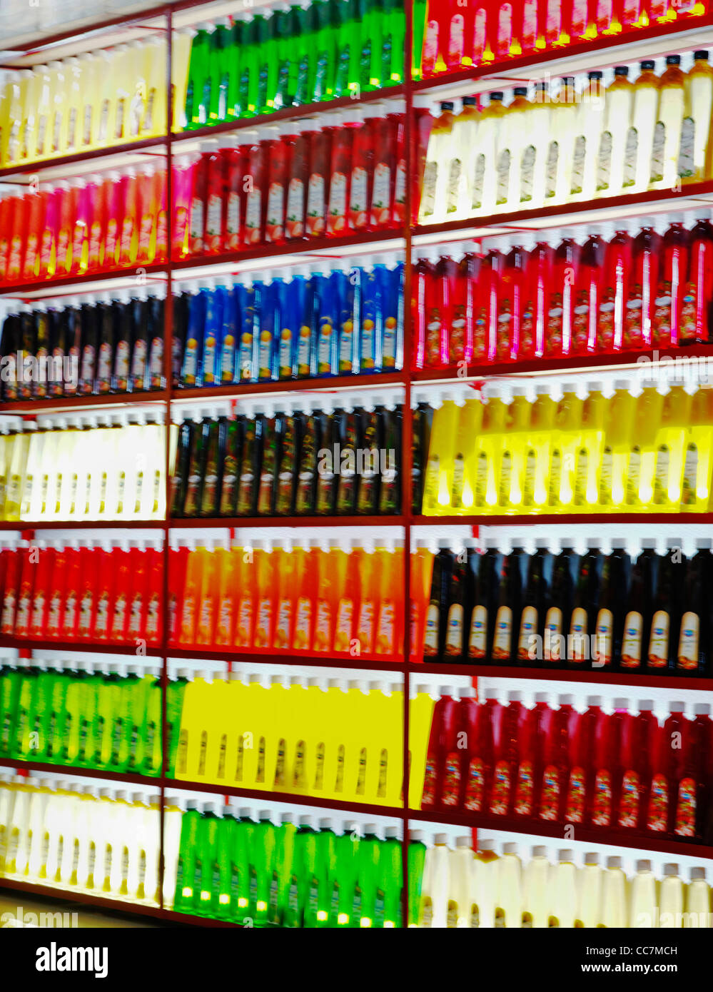 Vertical display of multi colored fruit juices at a store in India ...