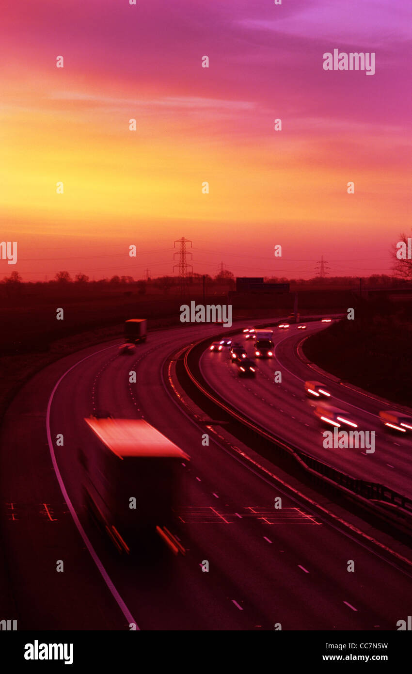 headlight trails of traffic travelling on the A1/M motorway at sunrise ...