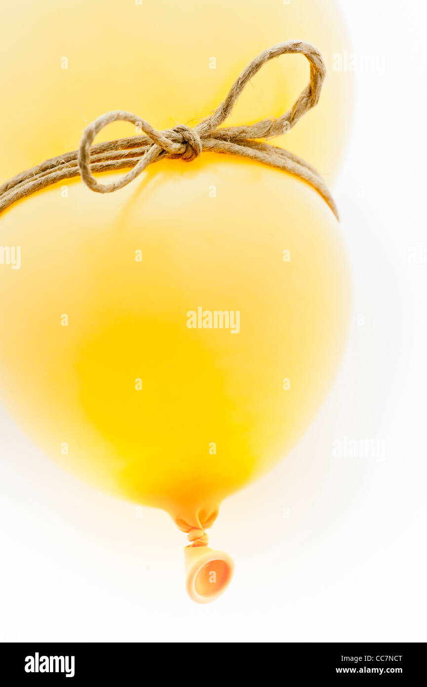 Yellow balloon with a string Stock Photo - Alamy