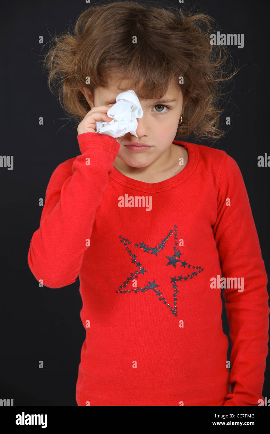 Young girl drying her tears Stock Photo - Alamy