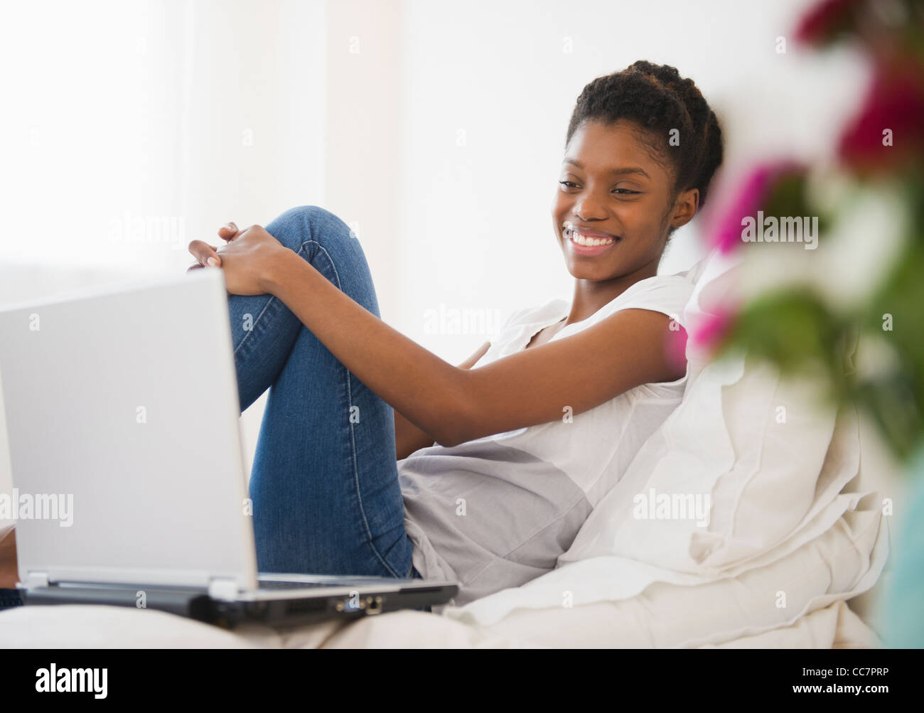 Young woman reclining bed using laptop hi-res stock photography and ...