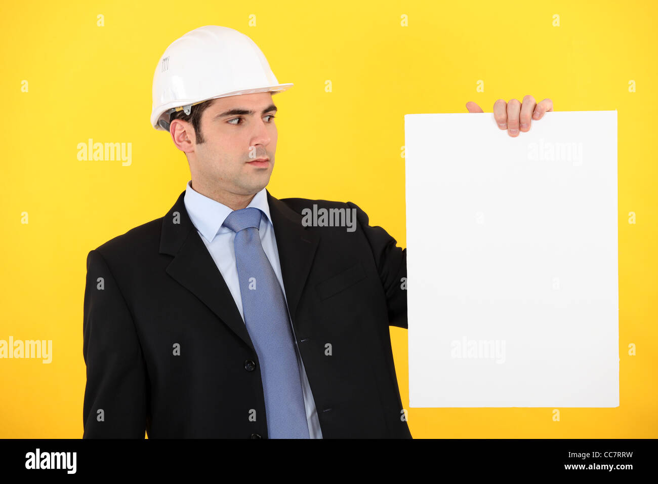 Engineer holding up a blank sign Stock Photo - Alamy