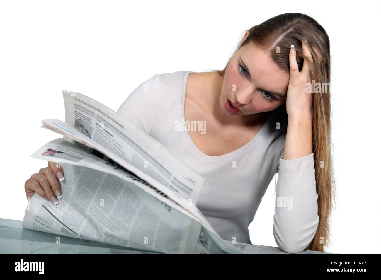 Woman reading a newspaper in shock Stock Photo - Alamy