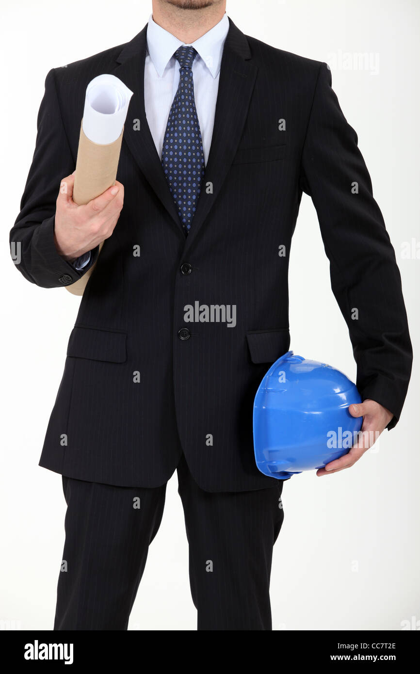 Architect carrying his helmet and a blueprint Stock Photo - Alamy