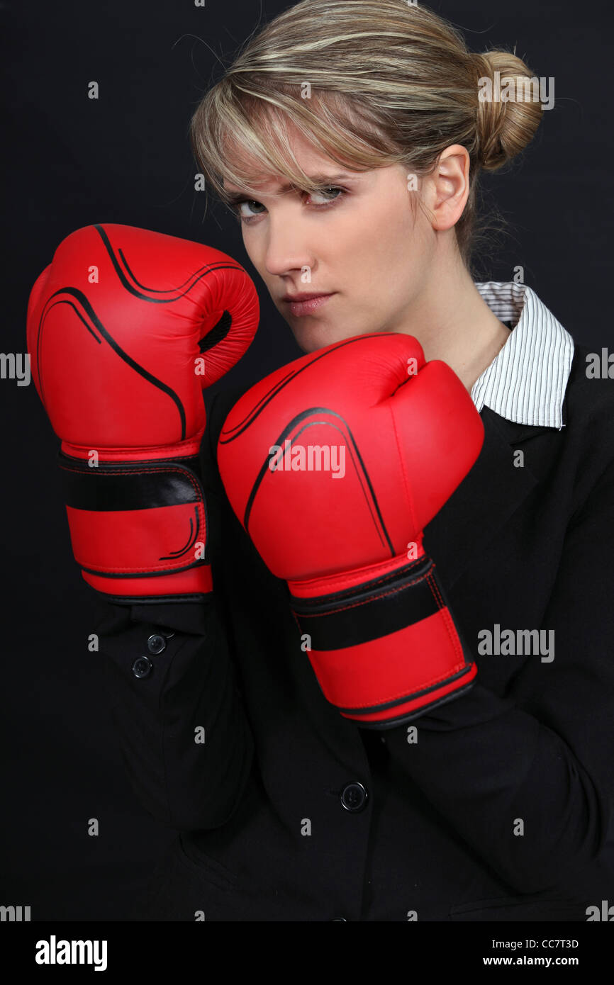 Female office worker wearing boxing gloves Stock Photo - Alamy