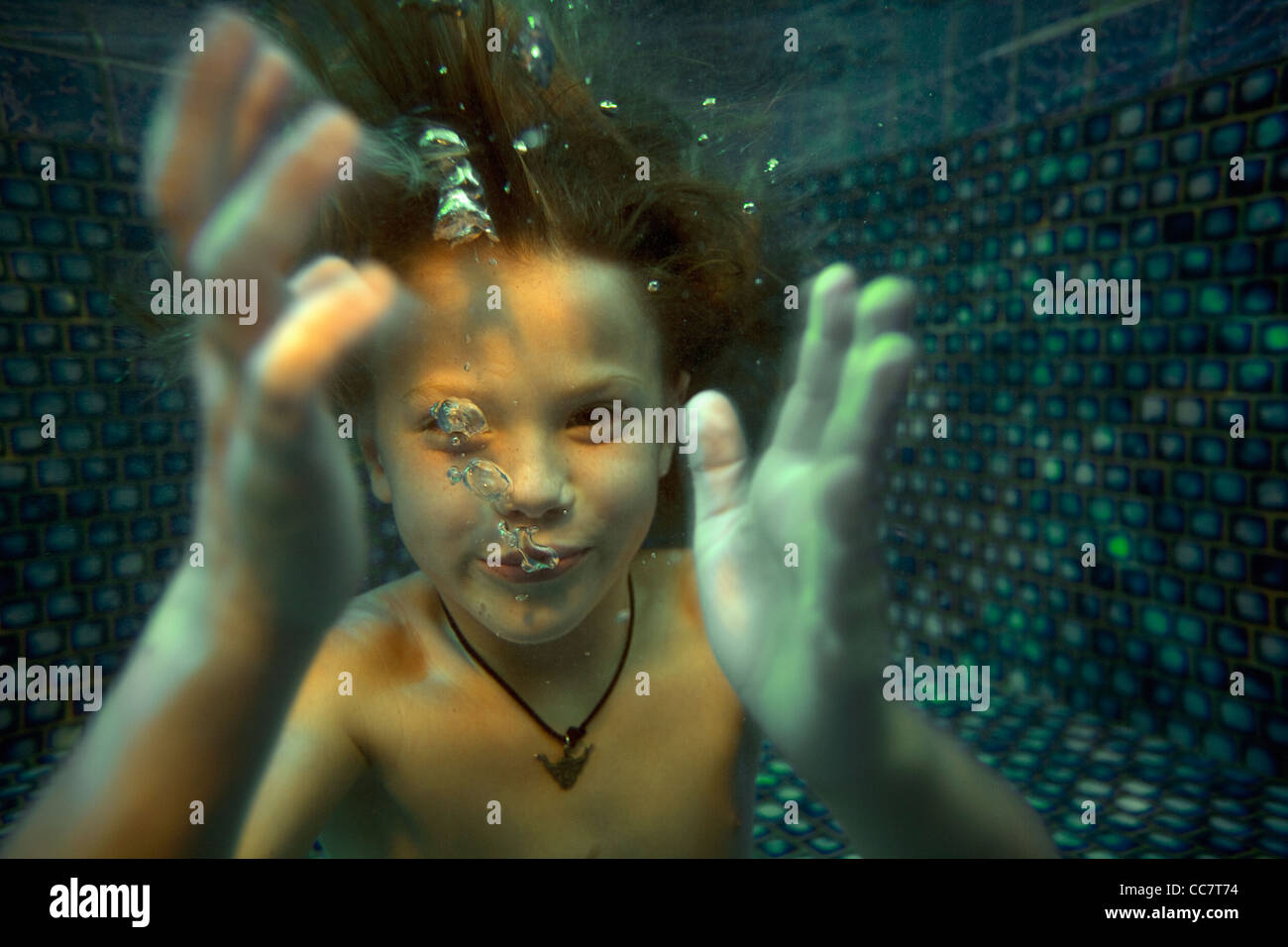 Boy swimming underwater in swimming pool Stock Photo - Alamy