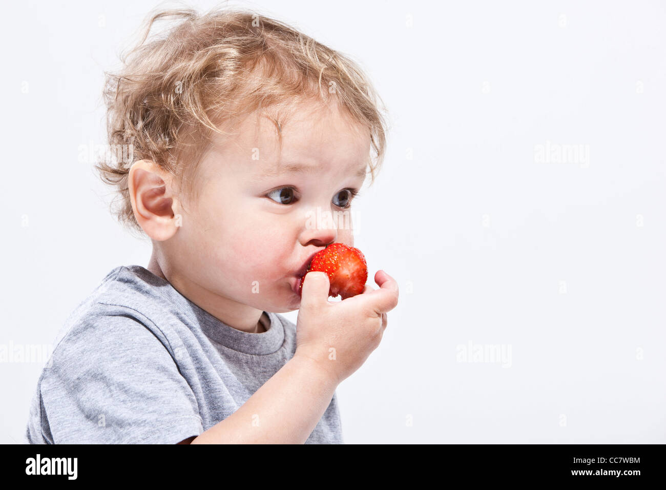 Boy Eating Strawberry Stock Photo - Alamy