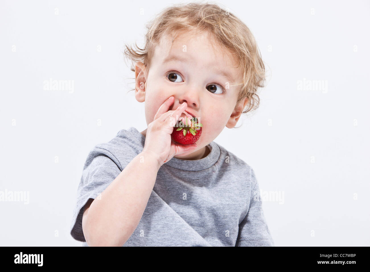 Boy Eating Strawberry Stock Photo - Alamy