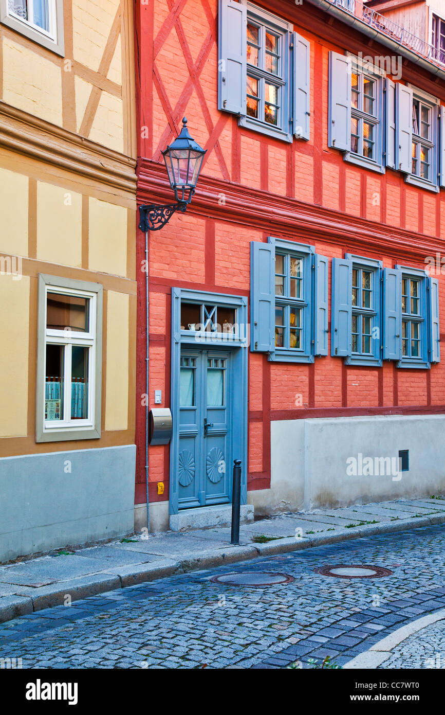 A row of half-timbered medieval houses in a cobbled street in the ...