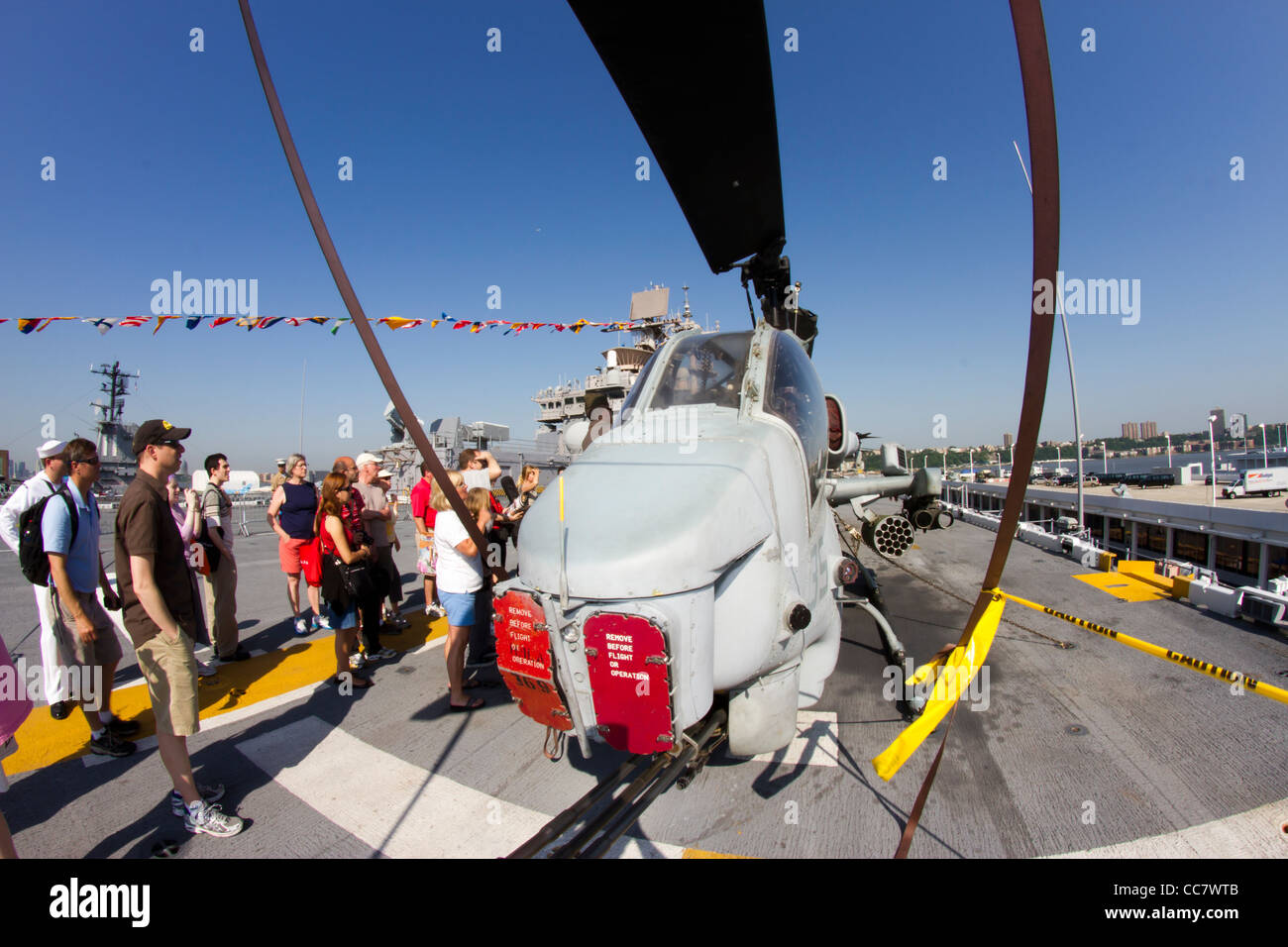 Visitors admire a Marine Corps AH-1W Super Cobra helicopter on the ...