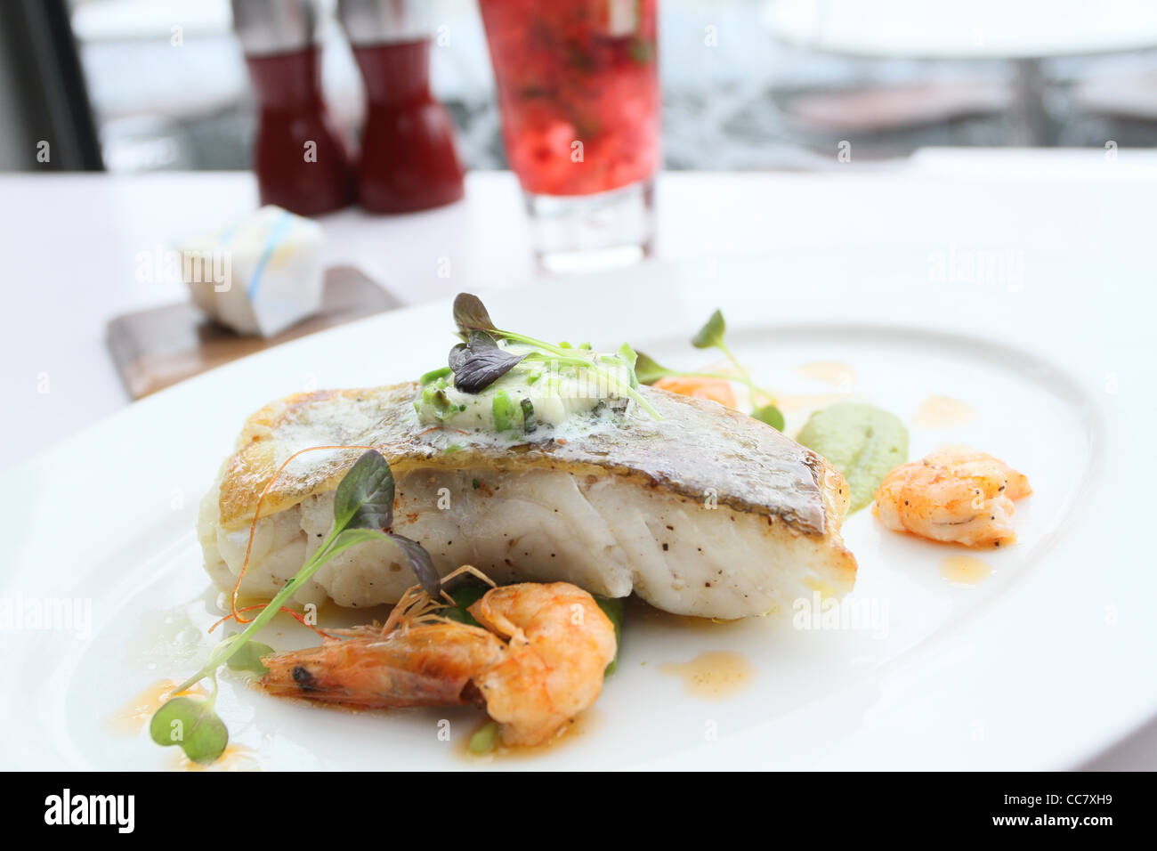 pan fried cod fillet served with garlic prawns, fresh asparagus & a pea ...