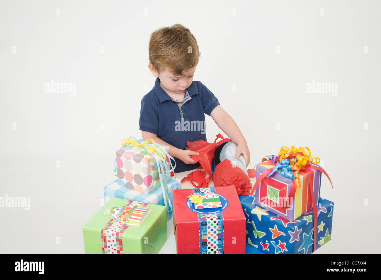 Young Boy opening Birthday Presents Stock Photo - Alamy