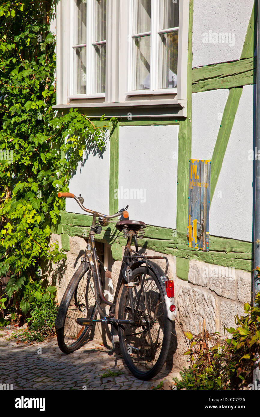 Rusty old bike in a cobbled street of half-timbered medieval houses in ...