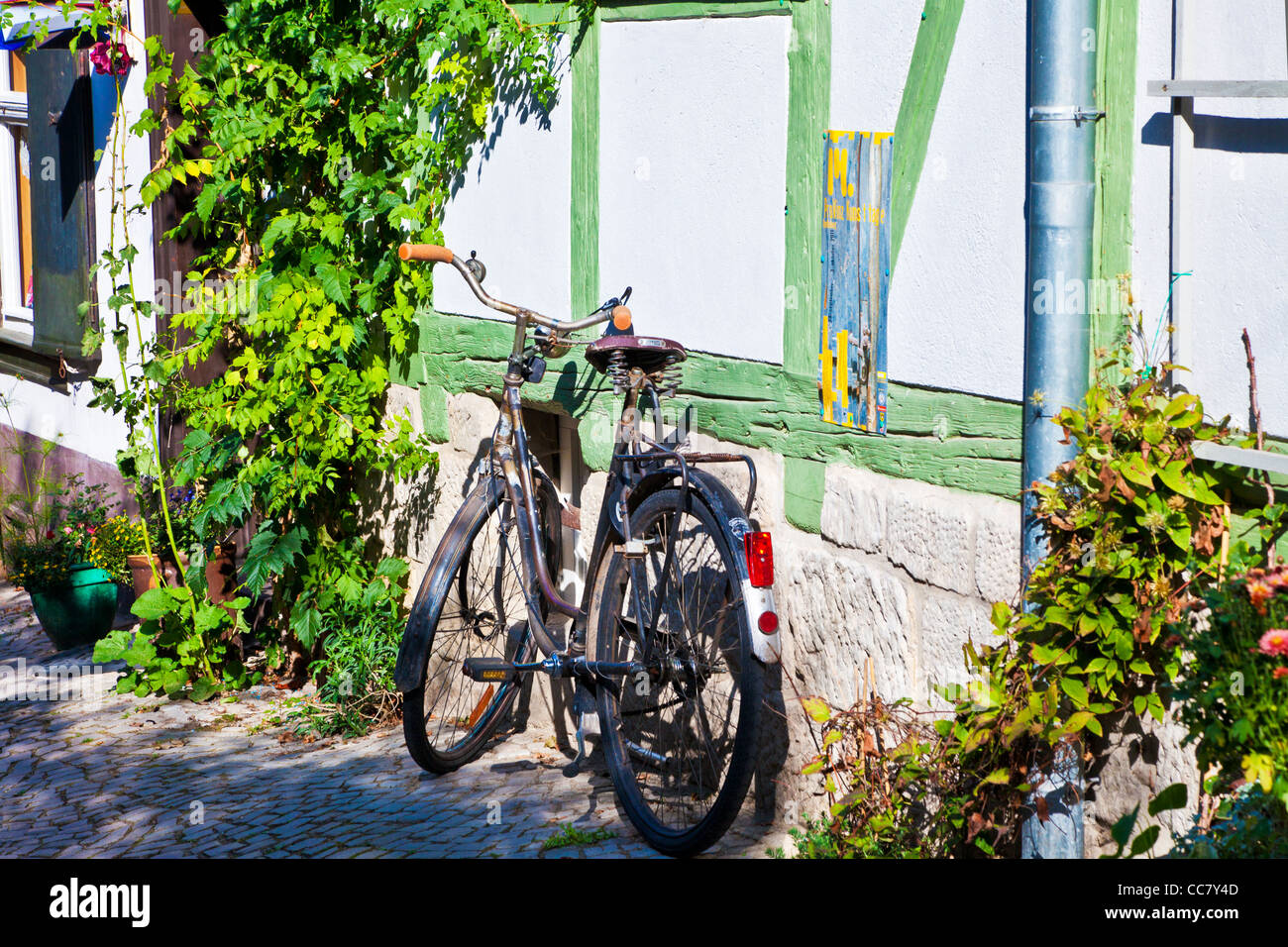 Rusty old bike in a cobbled street of half-timbered medieval houses in ...