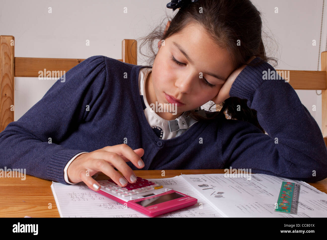 Young schoolgirl working out her homework alone Stock Photo - Alamy