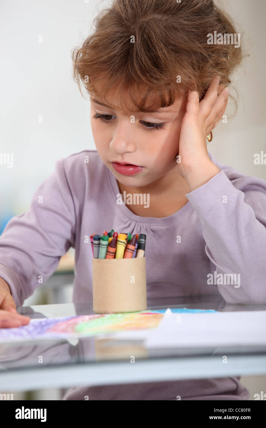 Girl with a pot of crayons Stock Photo - Alamy