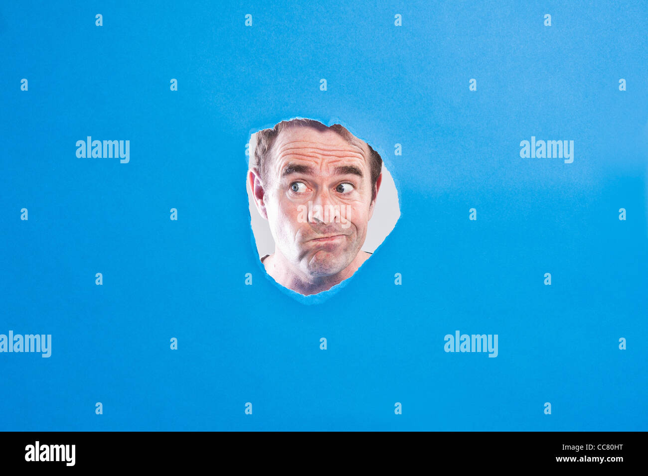 Man Looking Through Hole Stock Photo - Alamy