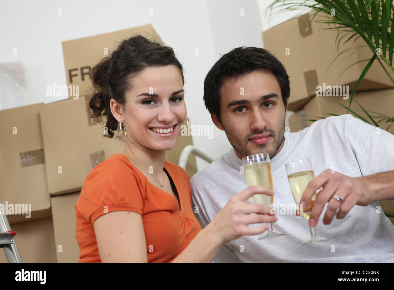 Couple celebrating purchase of first house together Stock Photo - Alamy