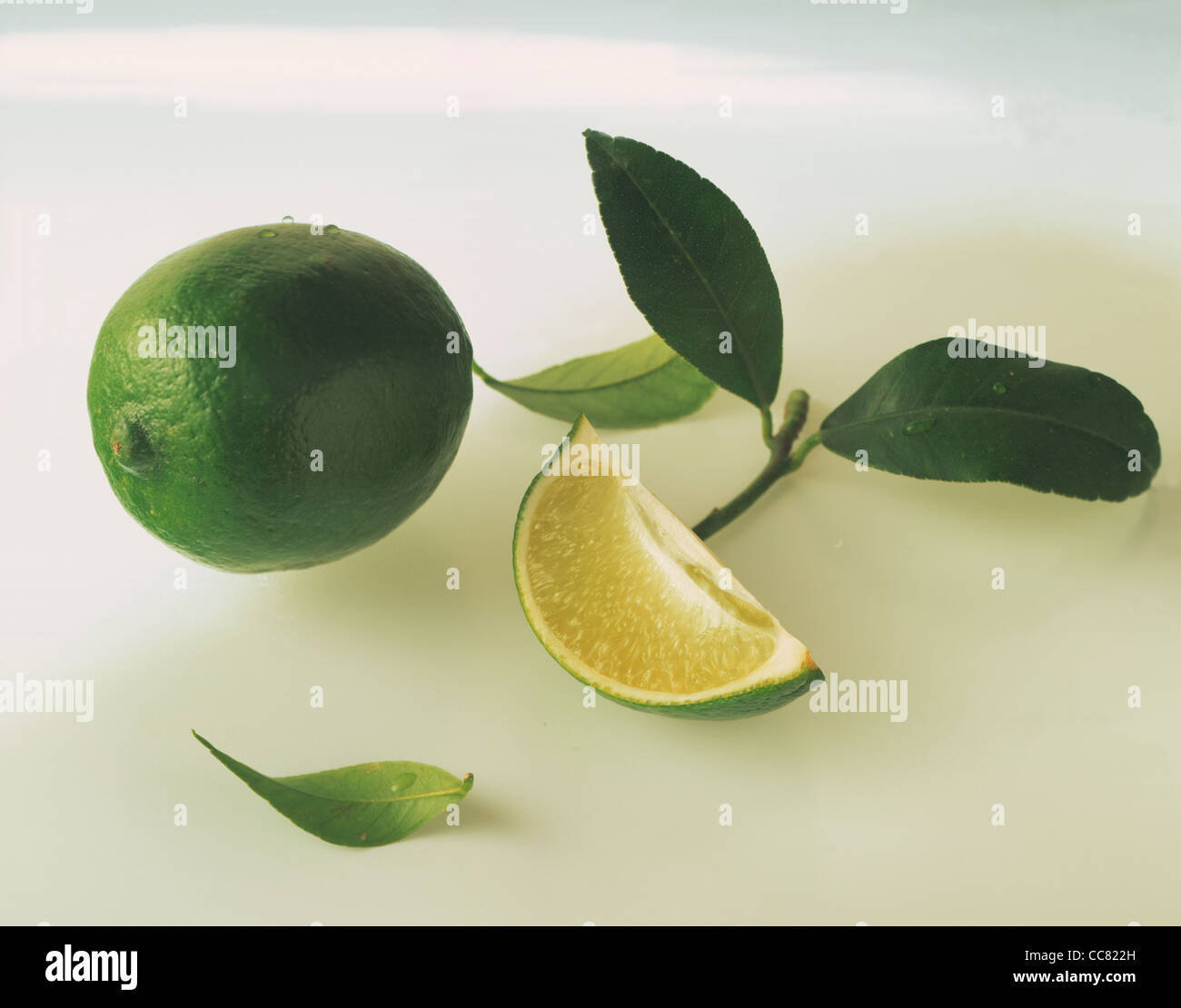 Cut out: Lime in whole, lime quarter, with leaves Stock Photo - Alamy