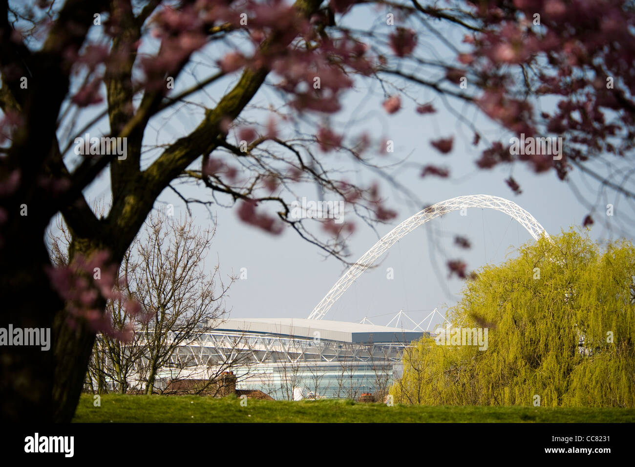 Wembley stadium seen in spring through the trees of Brent River Park in ...