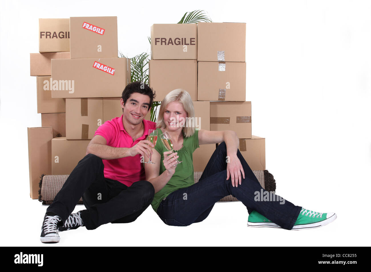 Happy woman packing boxes Cut Out Stock Images & Pictures - Alamy