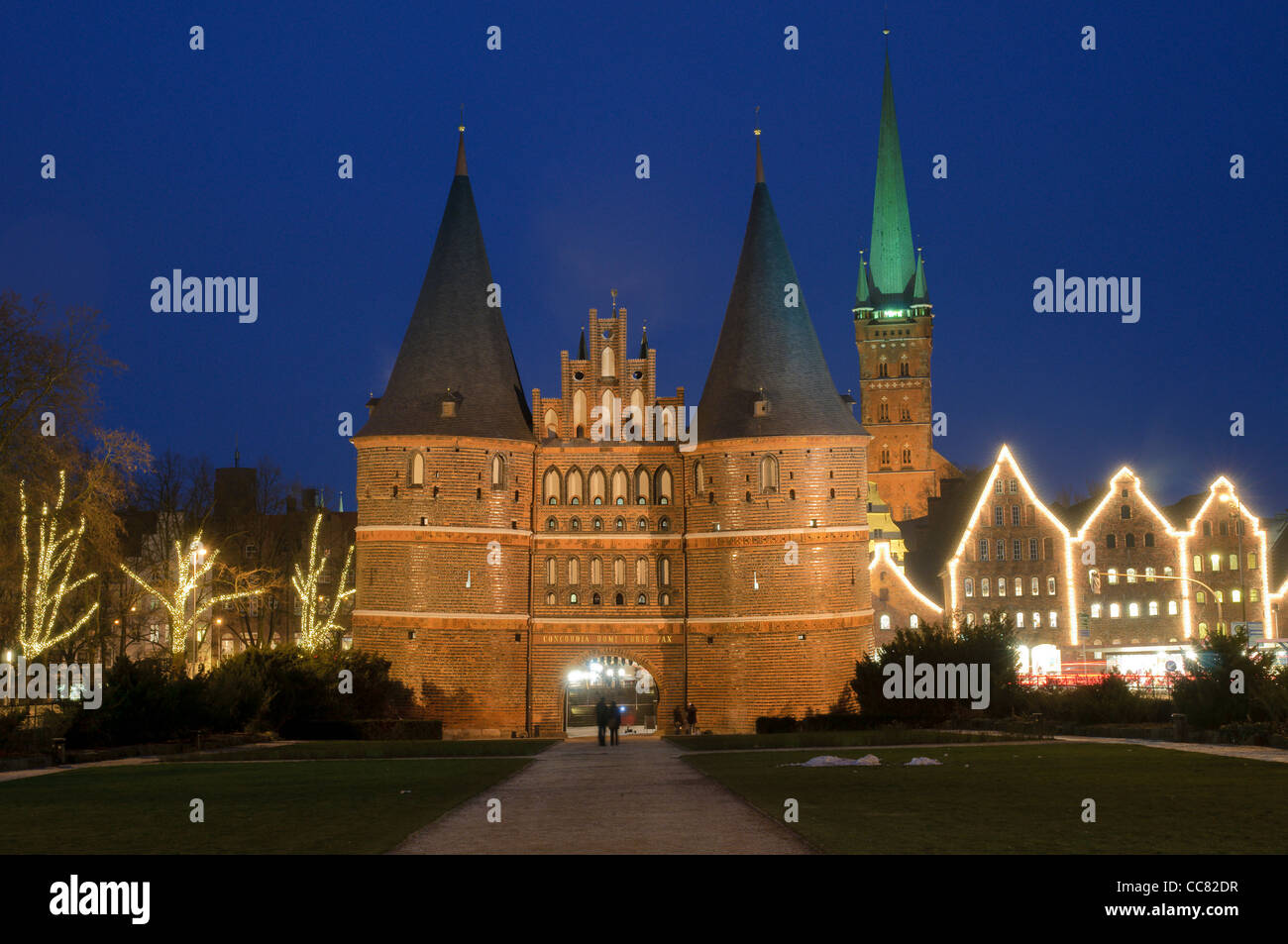 Illuminated Holstentor or Holsten Gate in the evening with Christmas ...