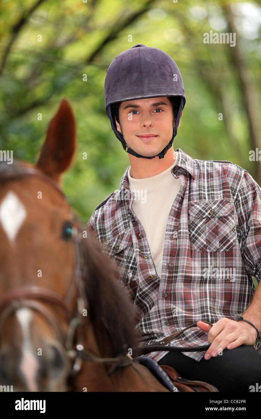 a young man riding a horse Stock Photo - Alamy