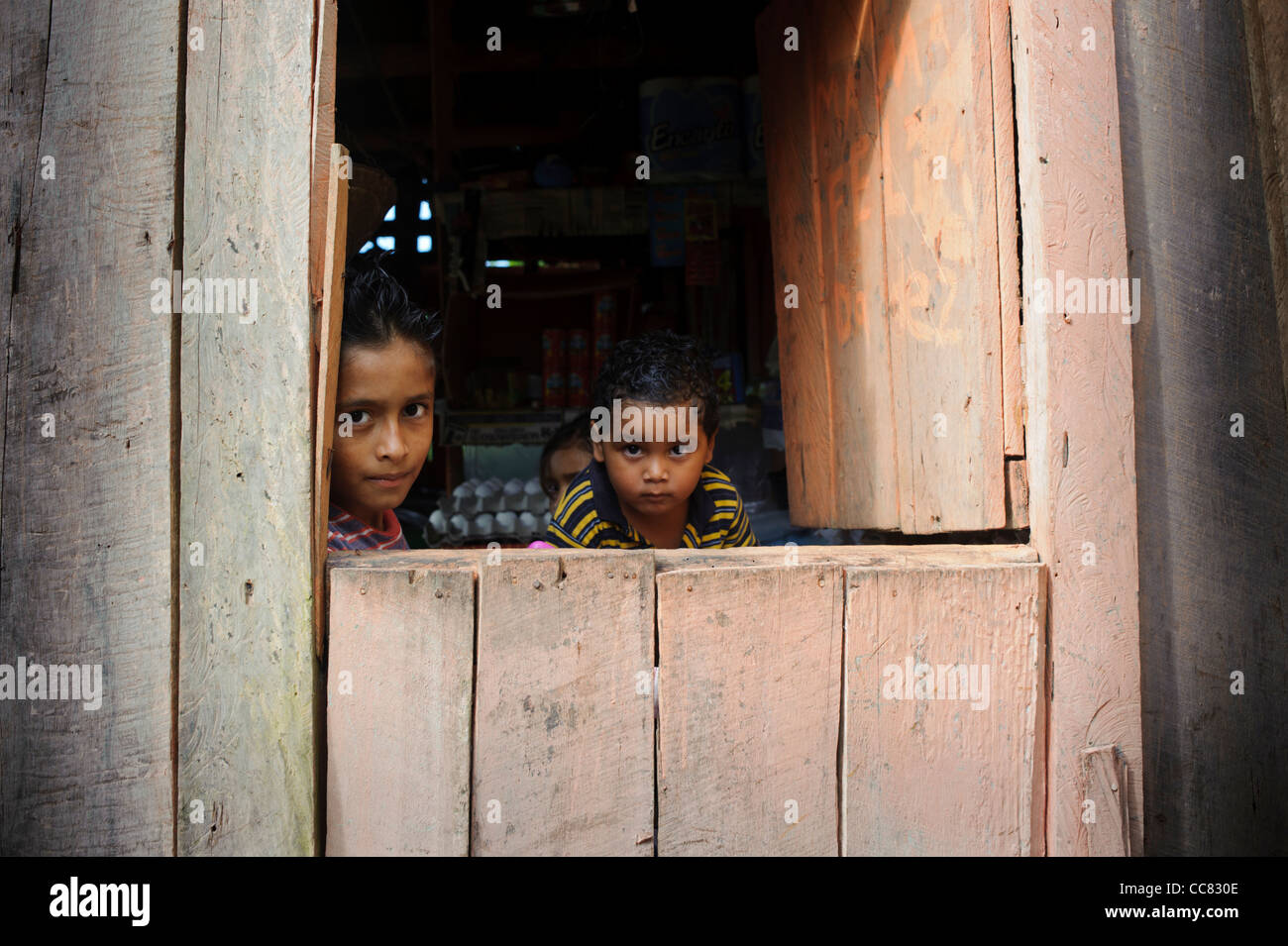Poor children inside of their home in Honduras which also acts as a ...