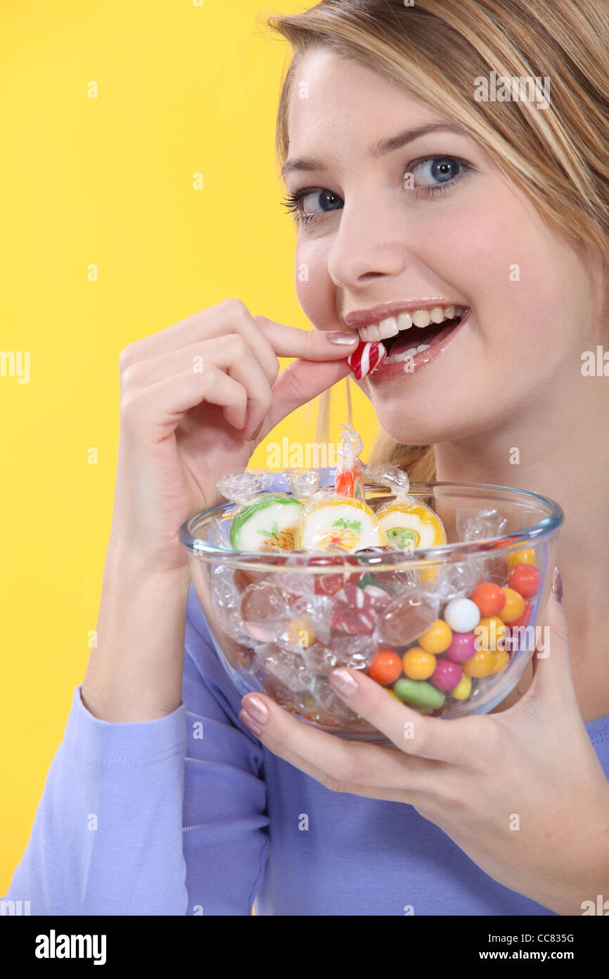 Young woman eating sweets Stock Photo - Alamy