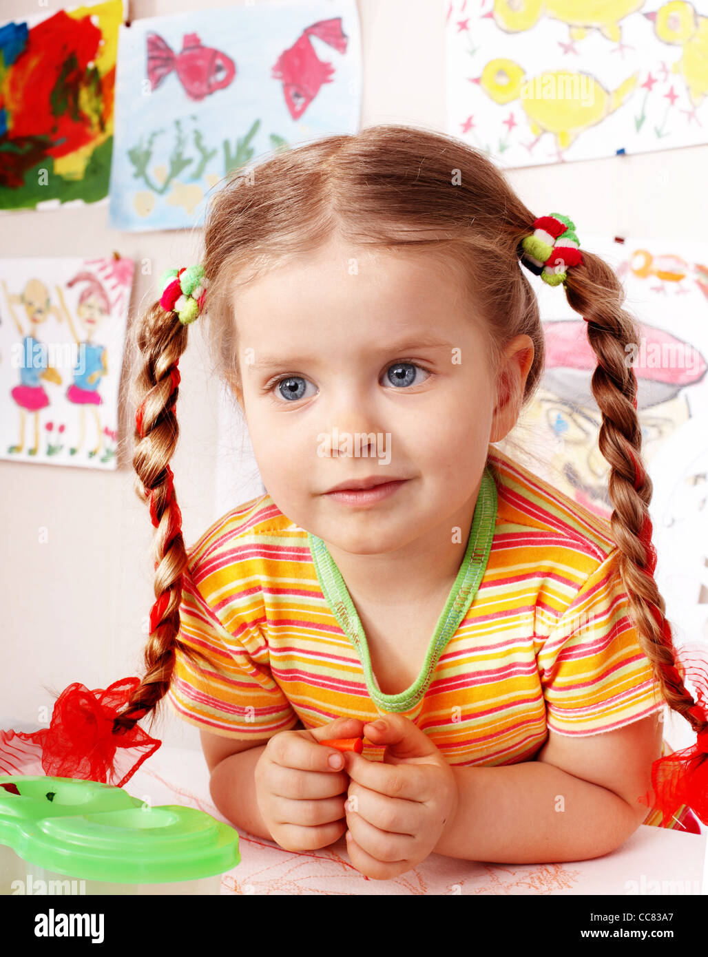 Child with piece of chalk draw in playroom Stock Photo - Alamy