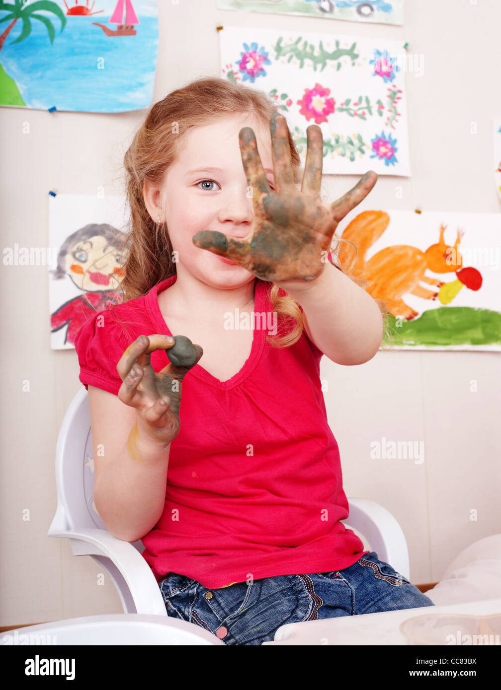 Child playing with clay in play room Stock Photo - Alamy