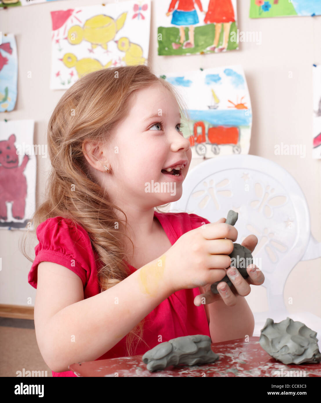 Child moulding from clay in play room Stock Photo - Alamy