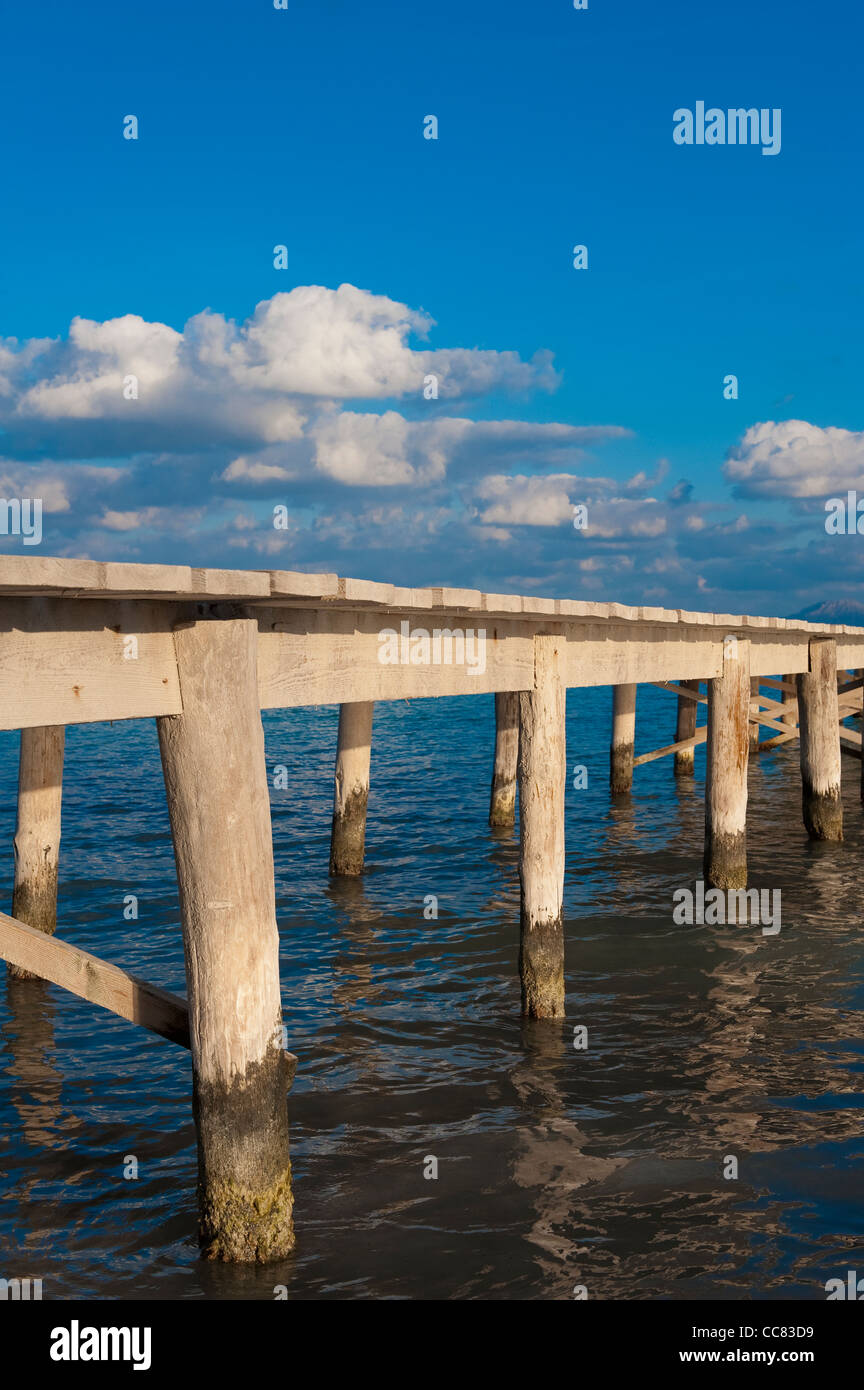 Wooden pier stretching out into a beautiful blue sea in Alcudia ...