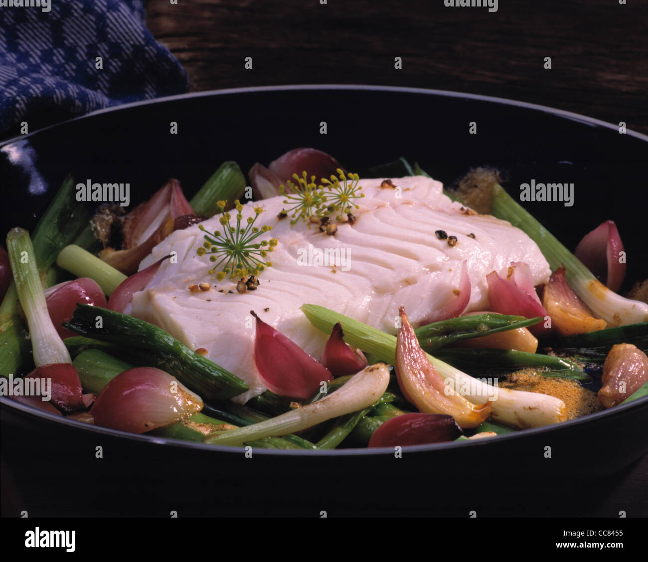 Haddock filet on juicy onion - vegetable Stock Photo - Alamy