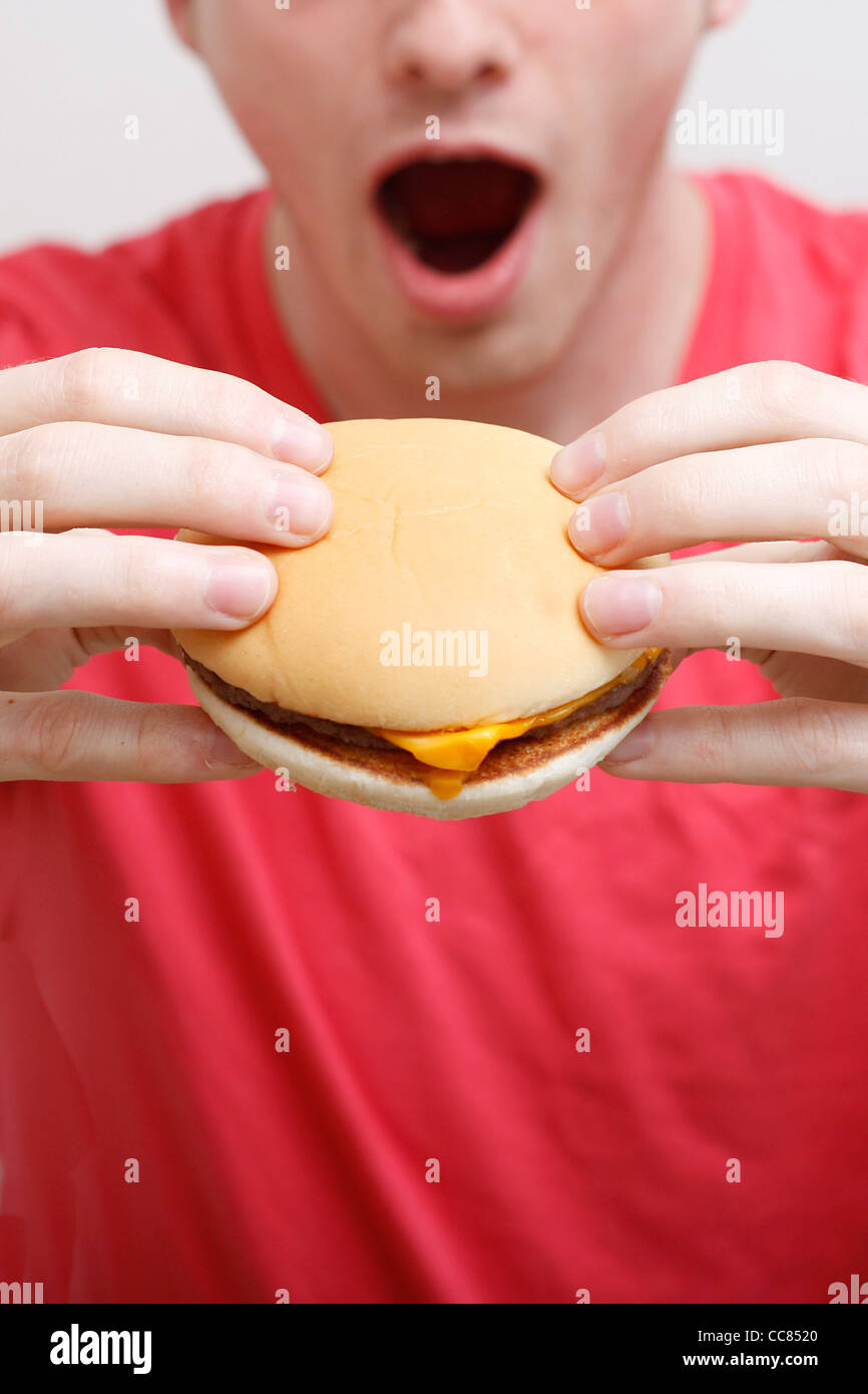 A man eating a burger Stock Photo - Alamy