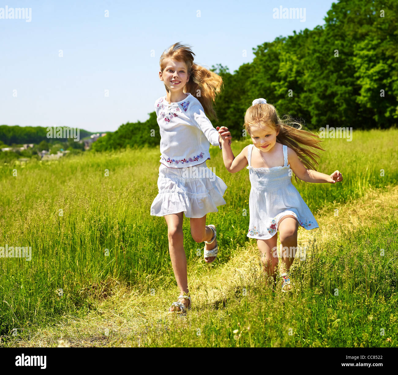 Group children running across green grass outdoor Stock Photo - Alamy